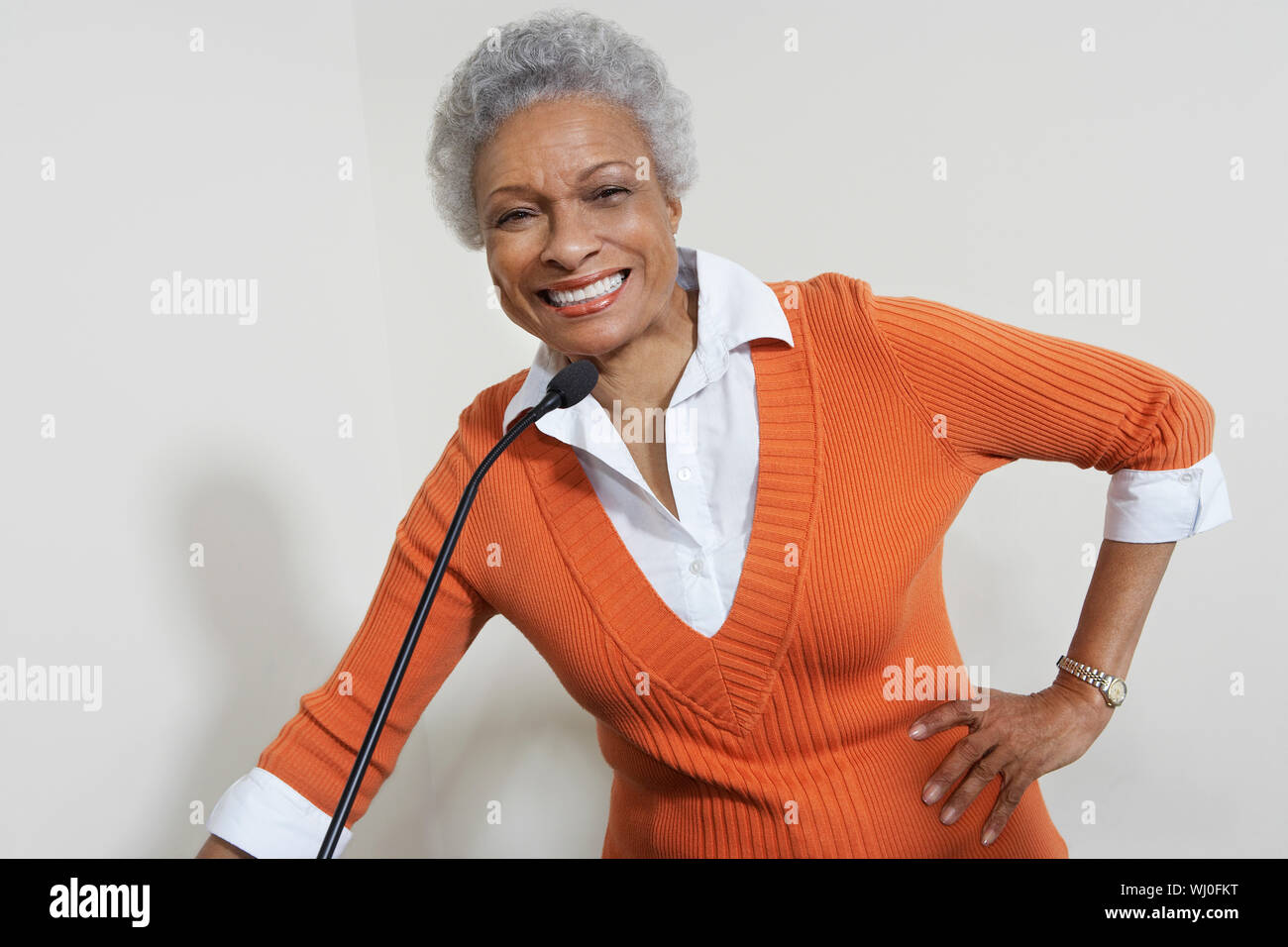 Female teacher using microphone indoors Stock Photo - Alamy