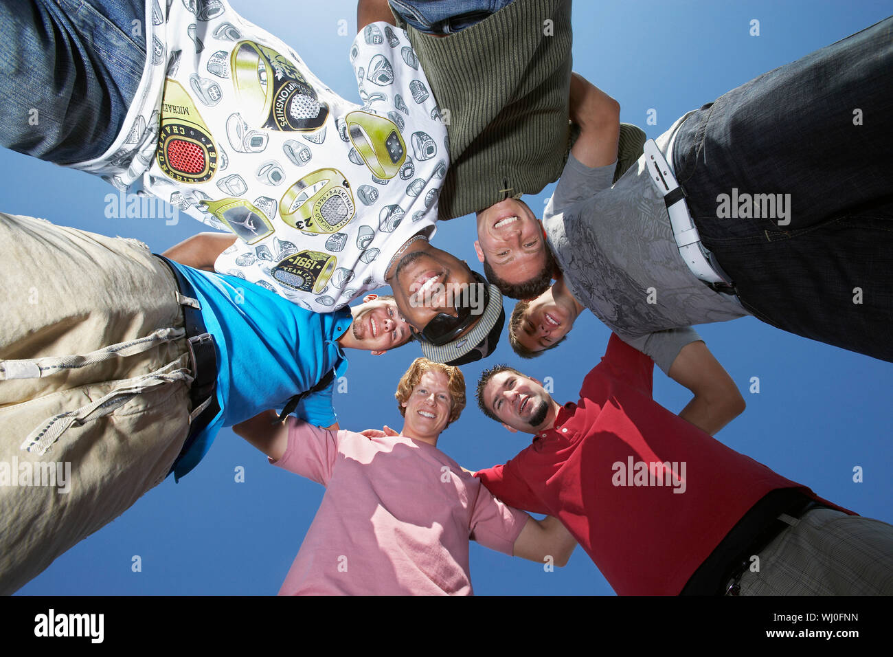 Group of young men in circle, view from below Stock Photo - Alamy