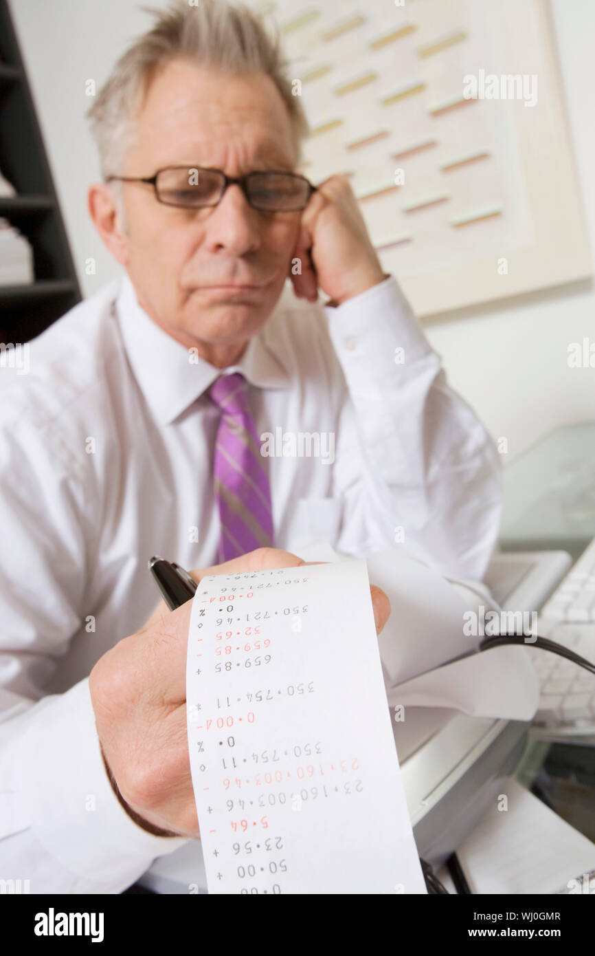 Tensed businessman sitting table hi-res stock photography and images ...