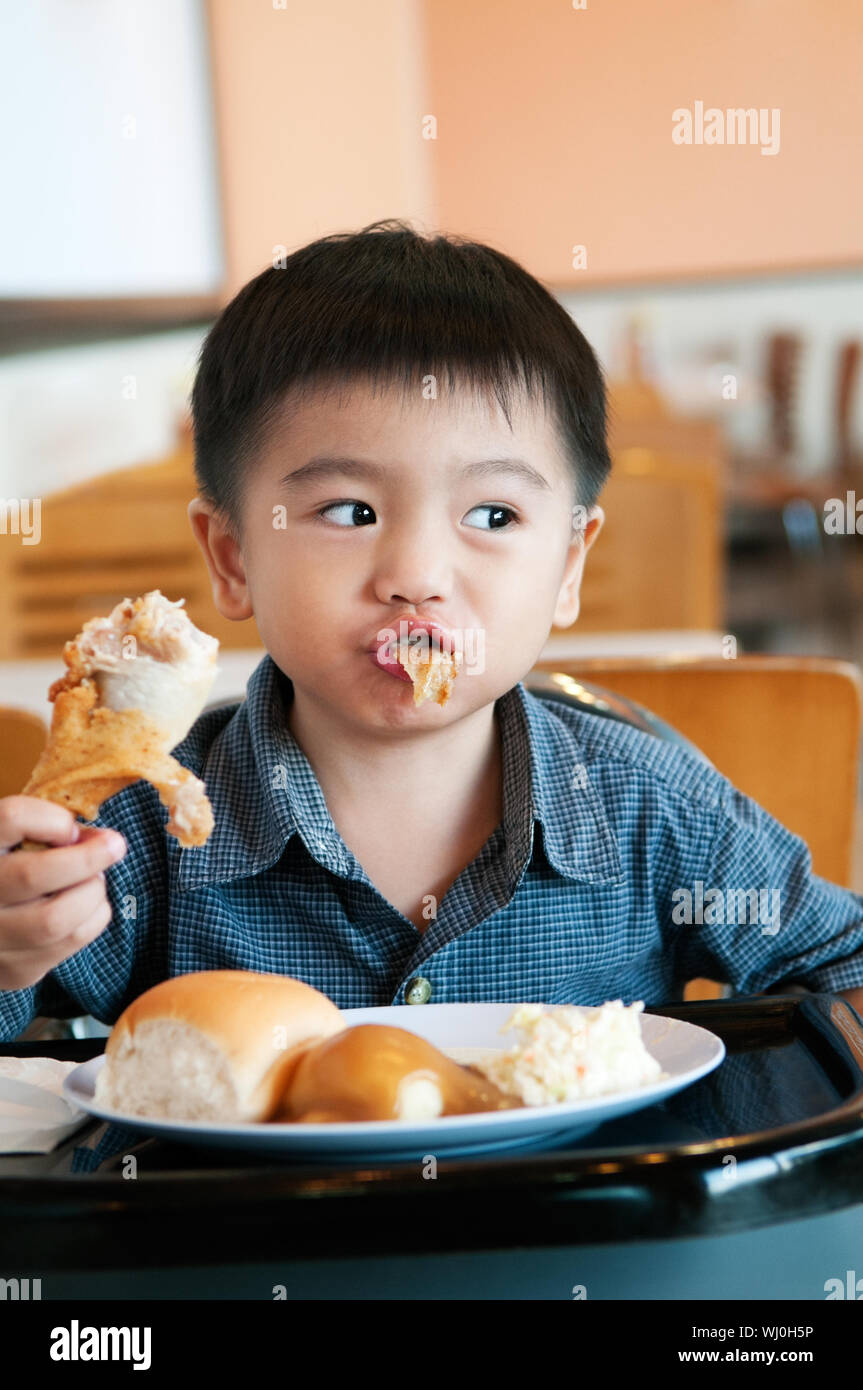 Boy sitting table eating plate hi-res stock photography and images - Alamy