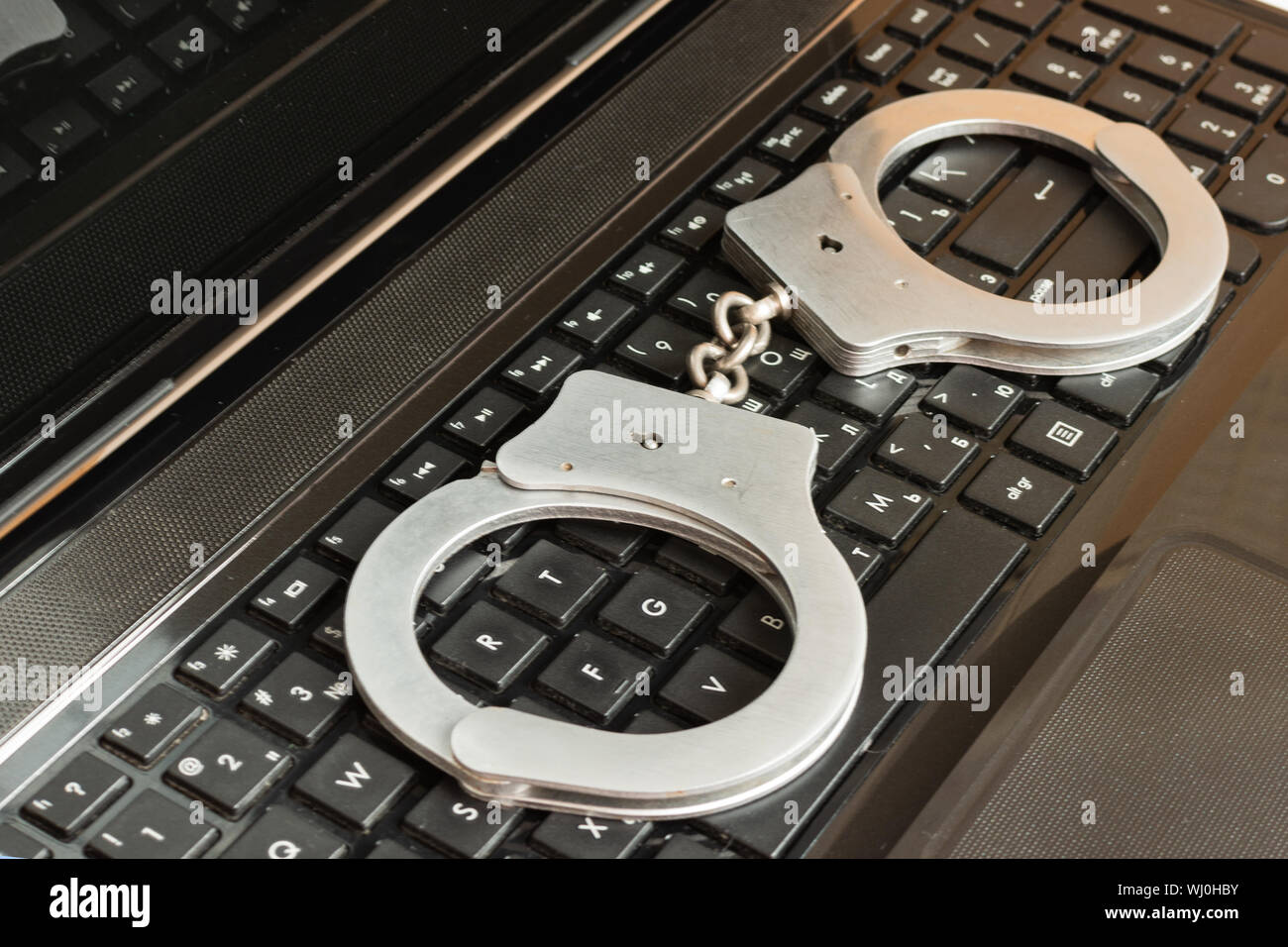 Computer keyboard and handcuffs top view. Criminal concept Stock Photo ...