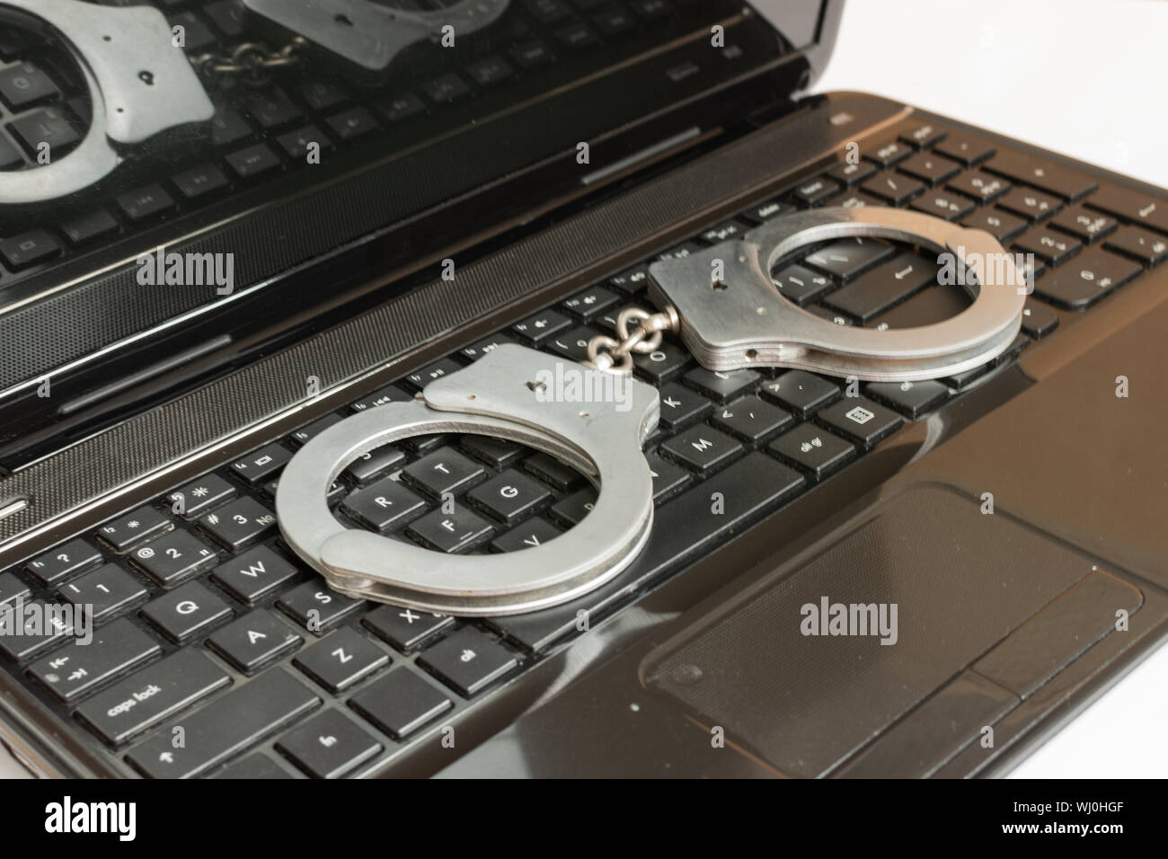 Computer keyboard and handcuffs top view. Criminal concept Stock Photo ...
