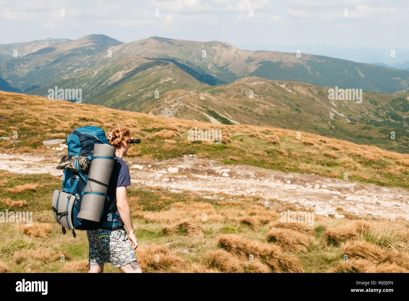 The man is looking into binoculars . Mountains landscape Stock Photo ...