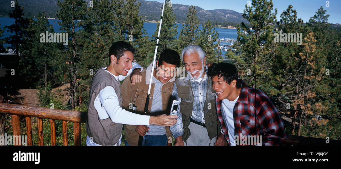 Four men posing for self portrait on balcony Stock Photo - Alamy