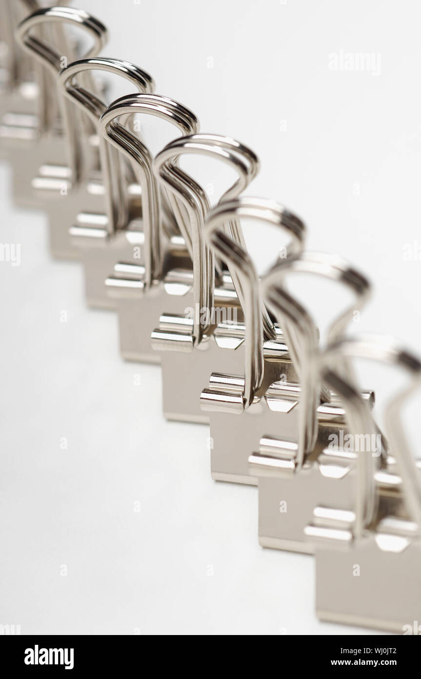 Row of binder clip on white background Stock Photo - Alamy