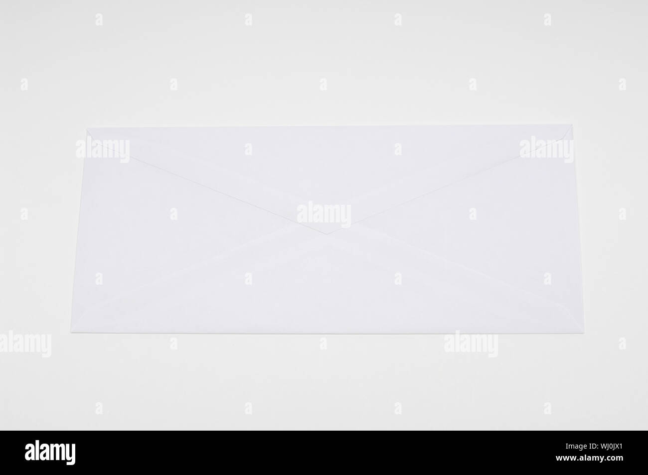 White envelope on white background Stock Photo - Alamy