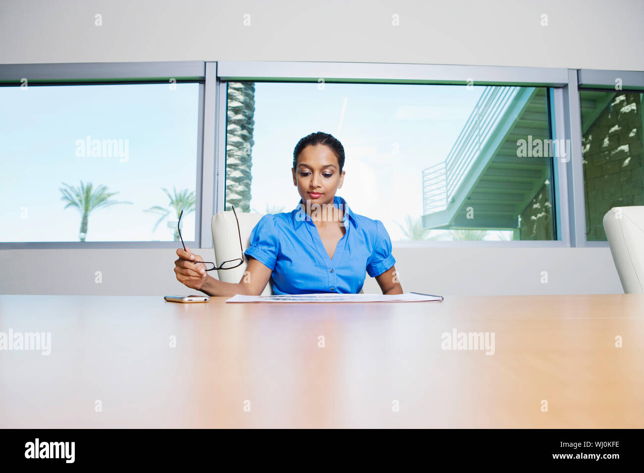 Beautiful Indian estate agent looking at building models in office ...