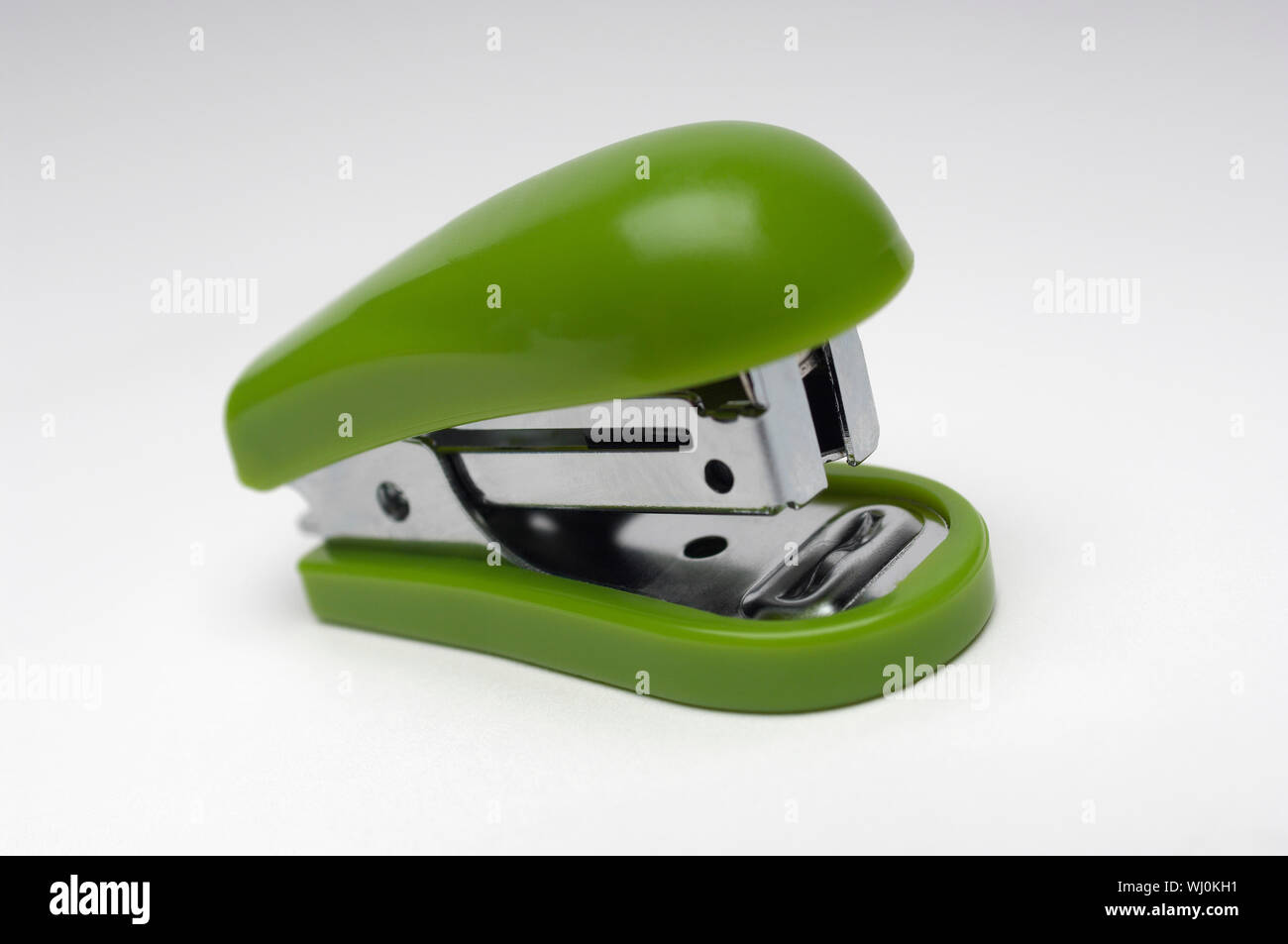 Green stapler on white background Stock Photo - Alamy