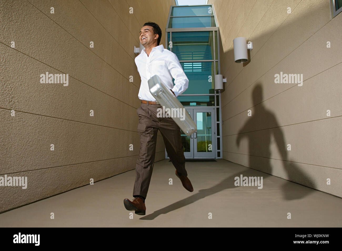 Full length of an excited Indian businessman running Stock Photo - Alamy