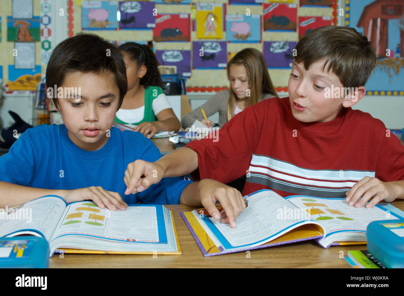 Pupils in classroom reading their textbooks Stock Photo - Alamy