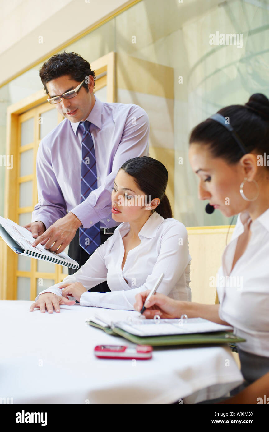 Three colleagues standing helping hi-res stock photography and images ...