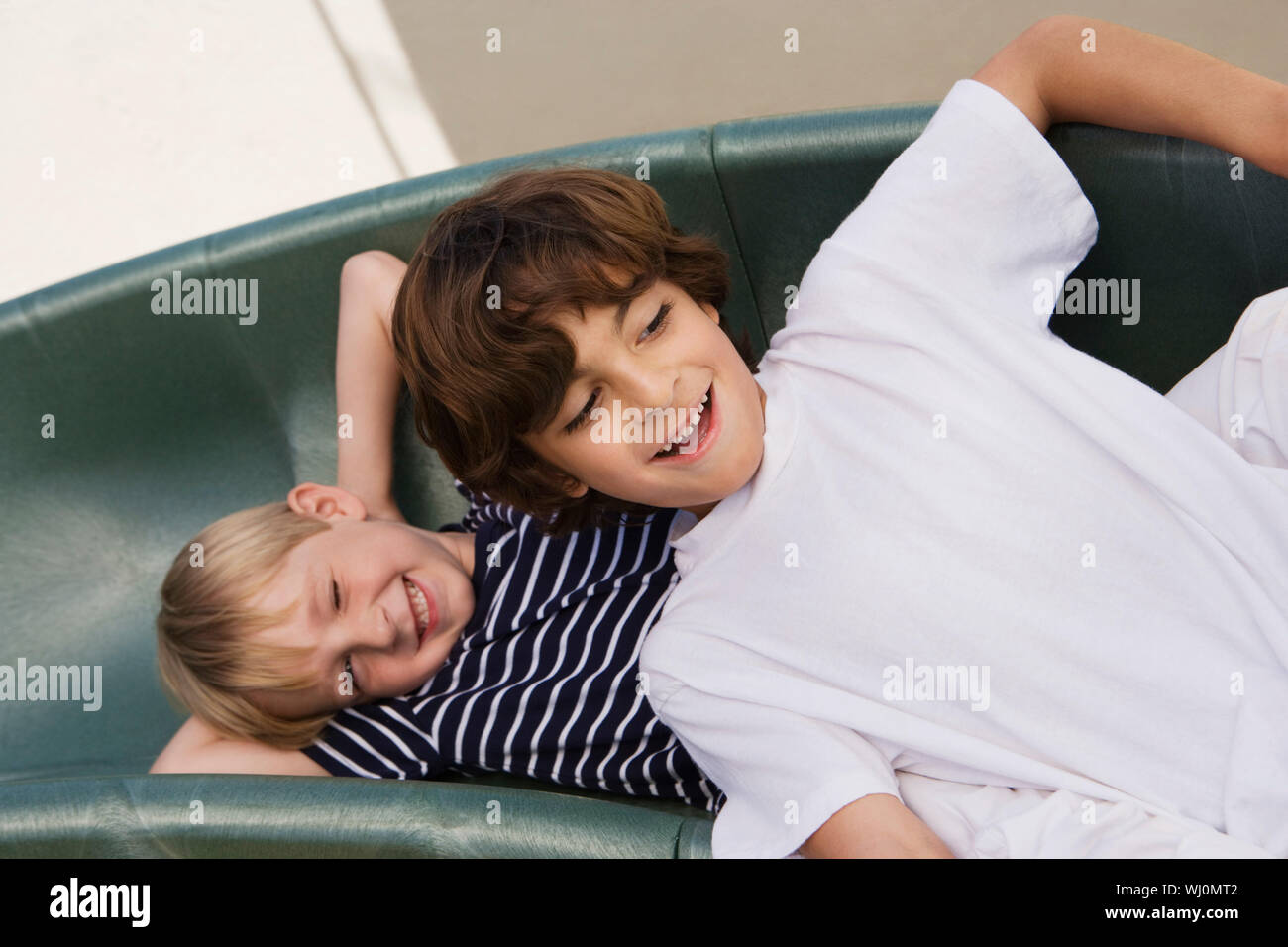 Little Boys Sliding down a Slide Stock Photo - Alamy