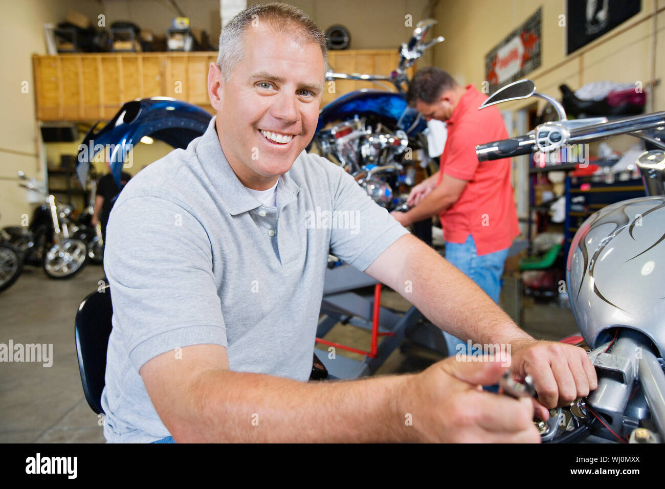 Mechanic Working on Motorcycle Stock Photo - Alamy
