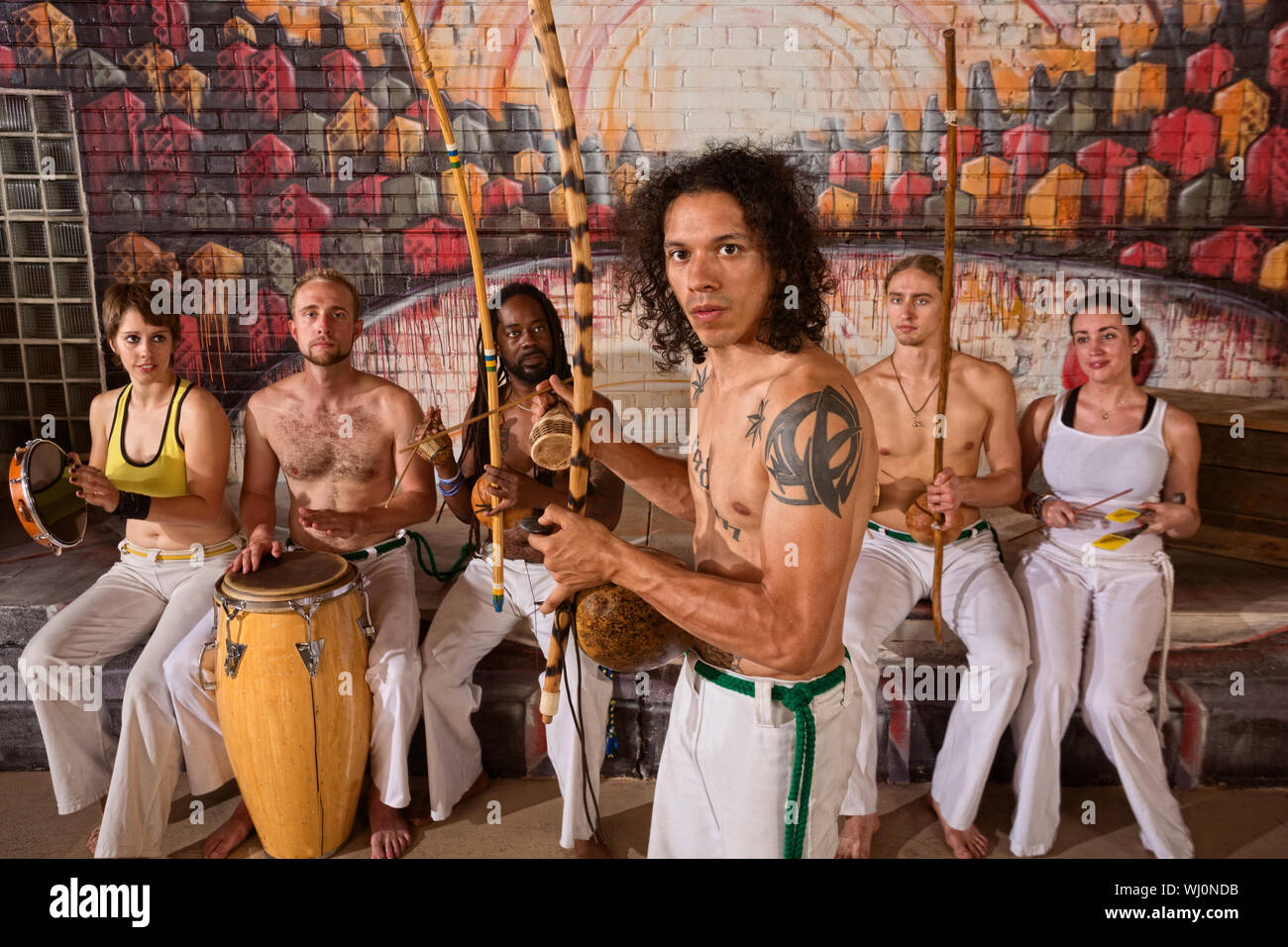 Handsome Latino Capoeira expert with musical instruments Stock Photo ...