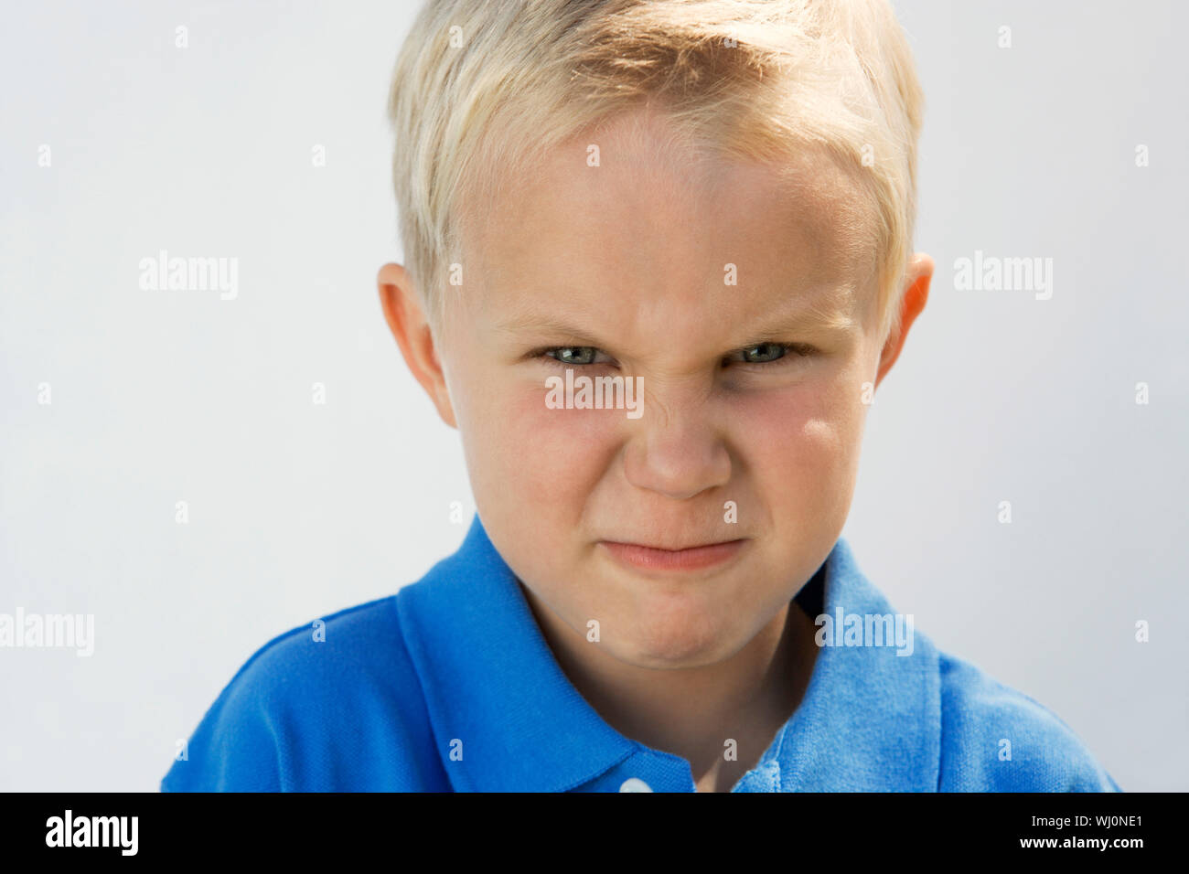 Young Boy Glaring Stock Photo - Alamy
