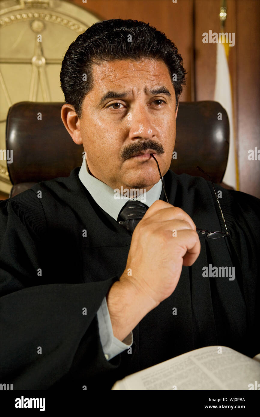 Pensive judge in court Stock Photo - Alamy