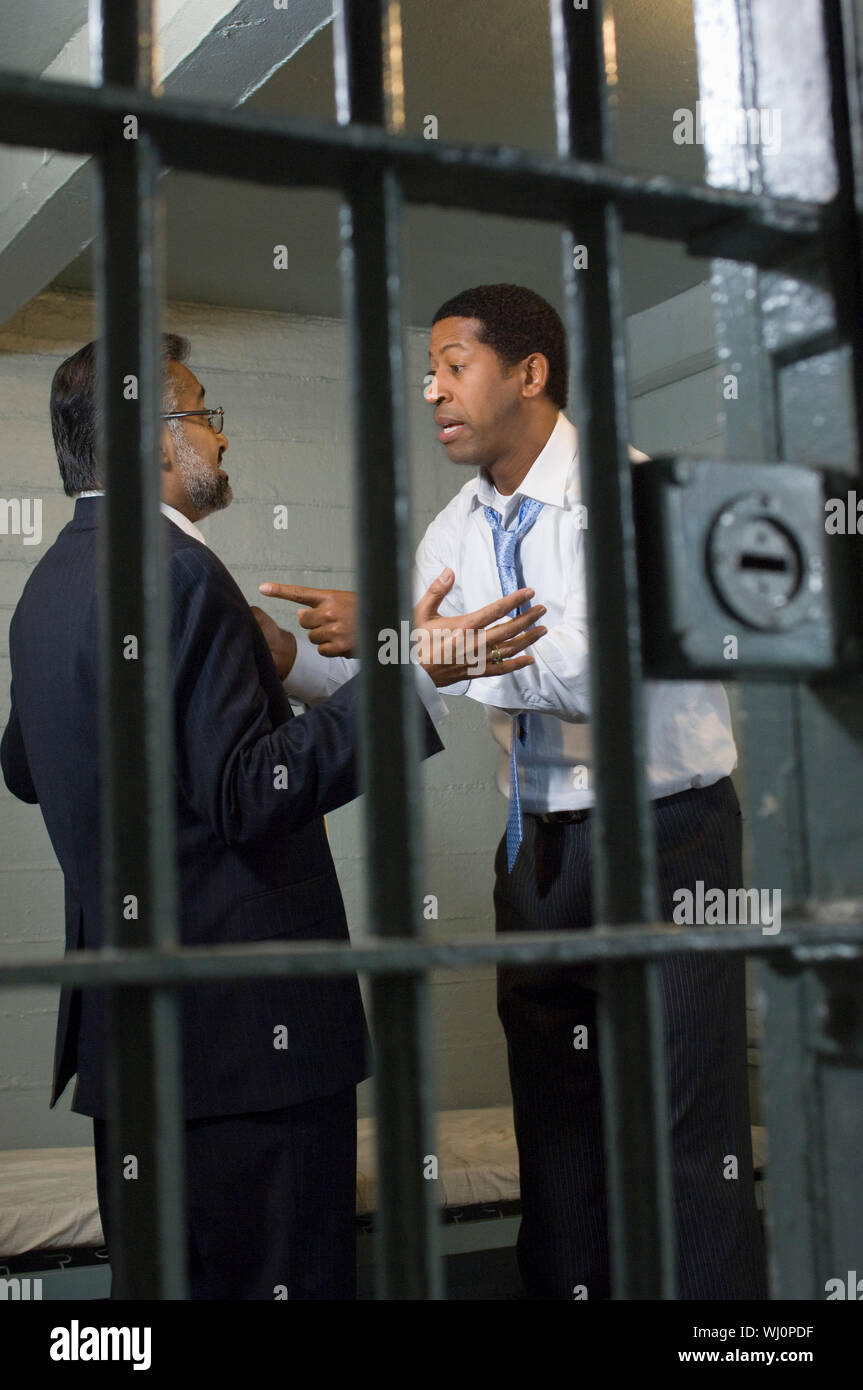 Two men arguing in prison cell Stock Photo - Alamy