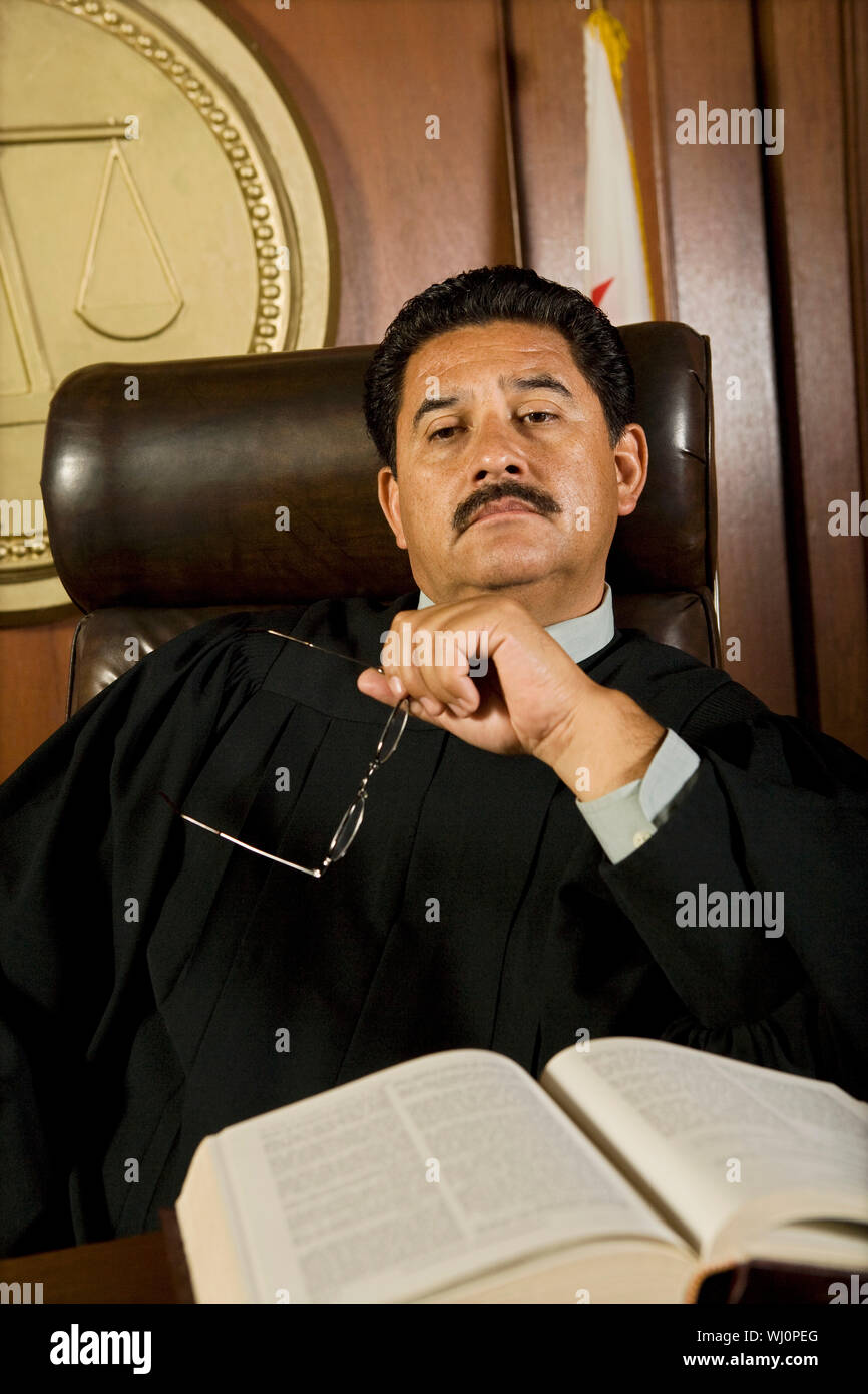 Pensive judge in court Stock Photo - Alamy