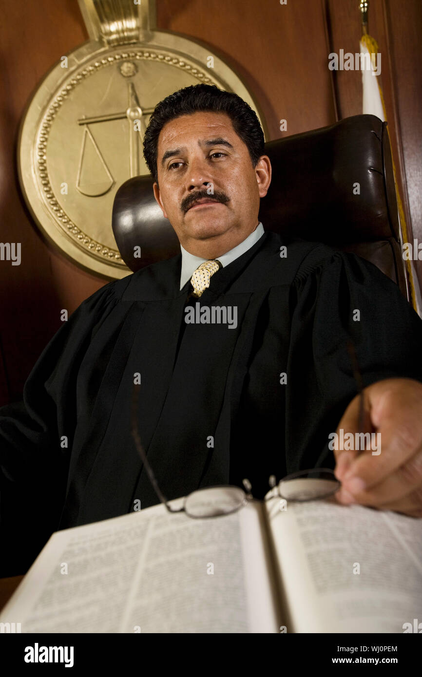 Pensive judge in court Stock Photo - Alamy