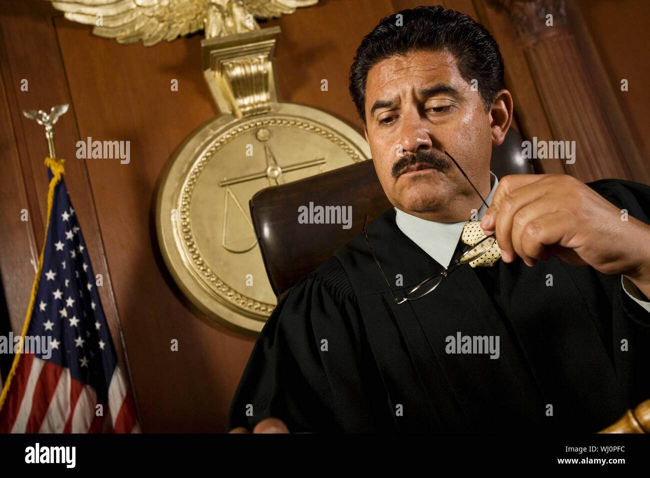 Pensive judge sitting in court Stock Photo - Alamy