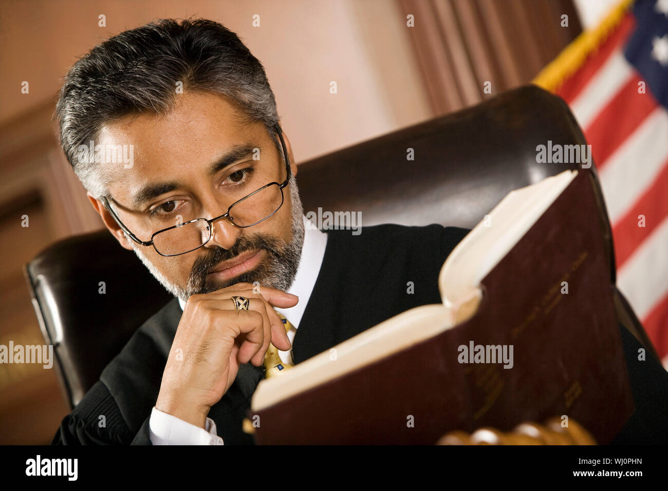 Middle-aged judge reading in a courtroom Stock Photo - Alamy