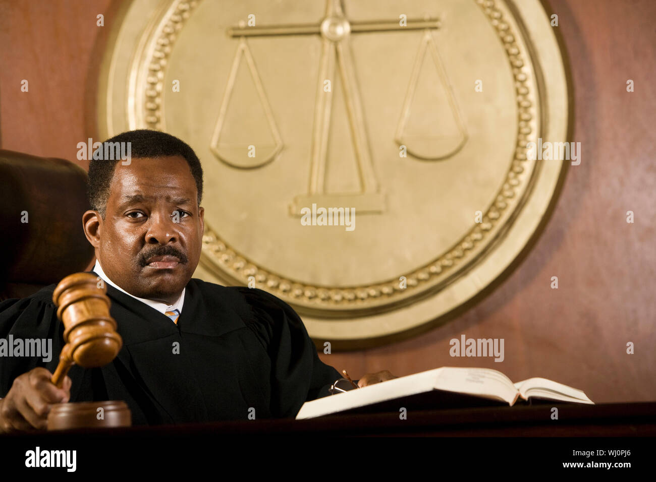 Middle-aged judge holding gavel Stock Photo - Alamy