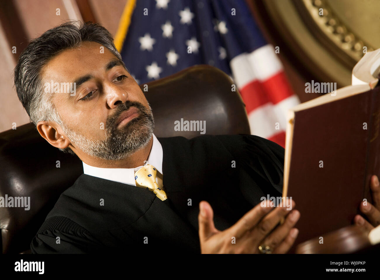 Middle-aged judge reading in a courtroom Stock Photo - Alamy