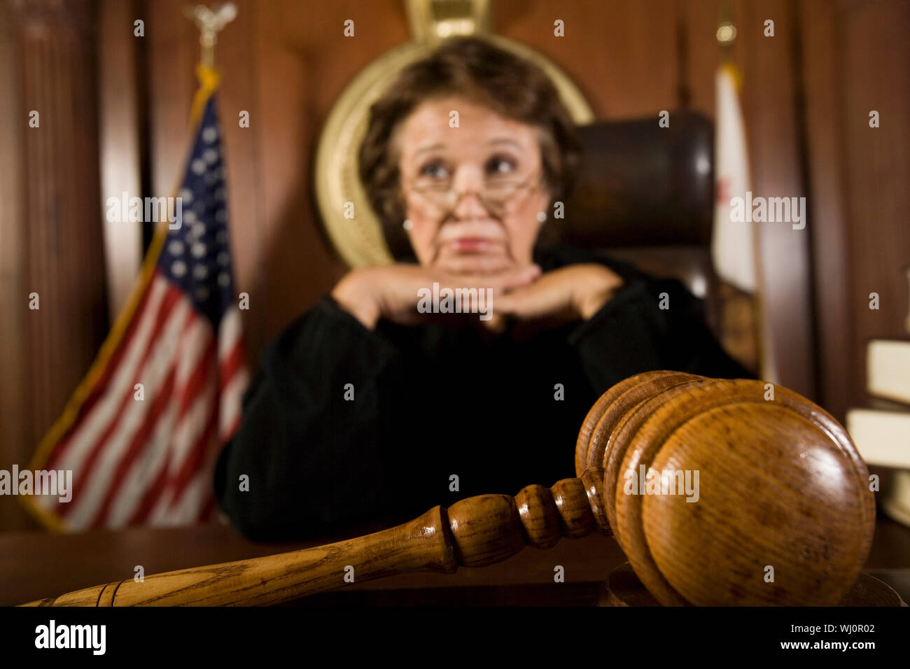 Female judge pondering over sentence Stock Photo - Alamy