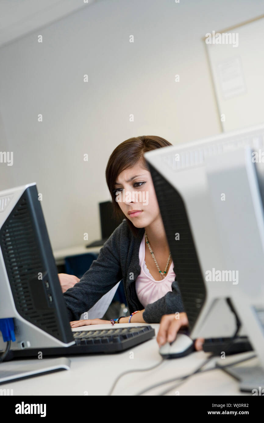 Beautiful young female student using computer in lab Stock Photo - Alamy