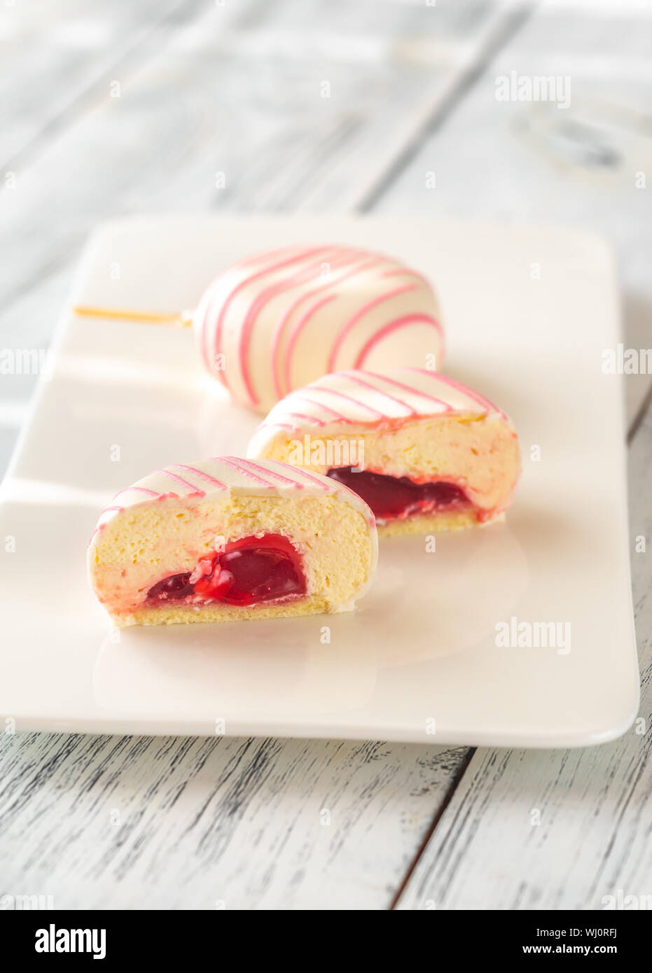 Cakes in the shape of popsicles on the white plate: cross section Stock ...
