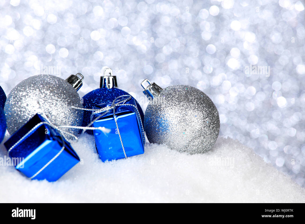 Christmas balls and gifts on snow Stock Photo - Alamy