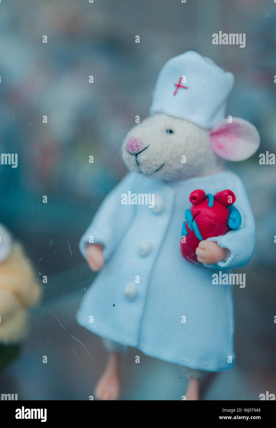 Small hand-made felt mouse in medical gown, doctor mouse, selective ...
