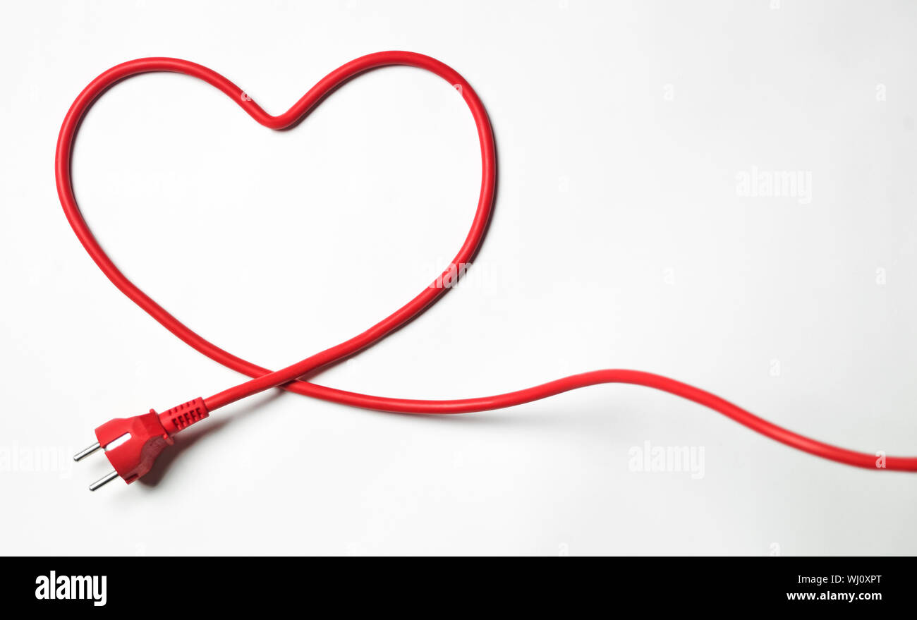Heartshaped red cable on white background Stock Photo - Alamy