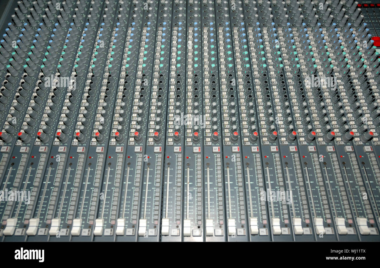 Audio mixing console in a recording studio. Faders and knobs of a sound ...