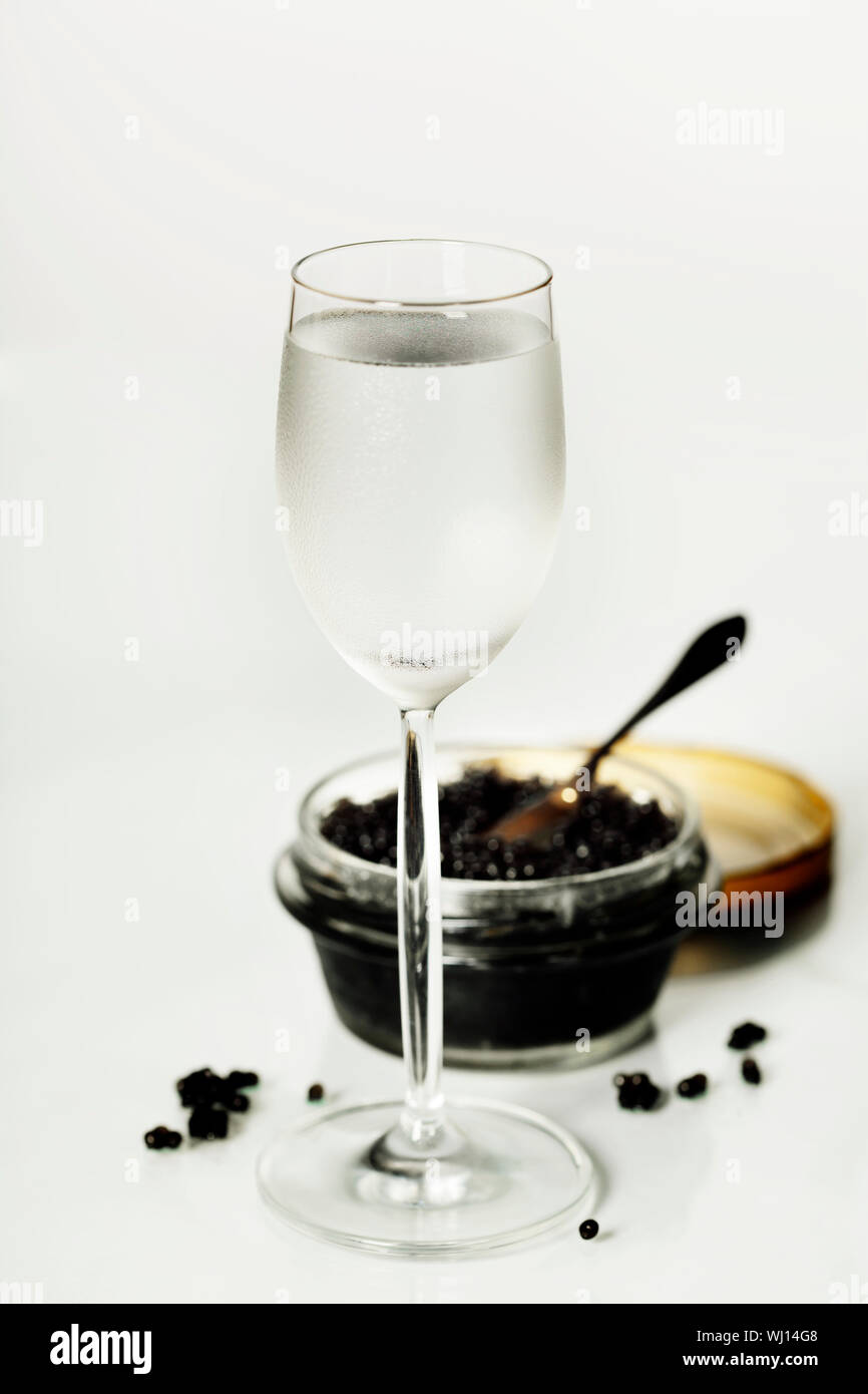 Vodka and black caviar over white Stock Photo - Alamy