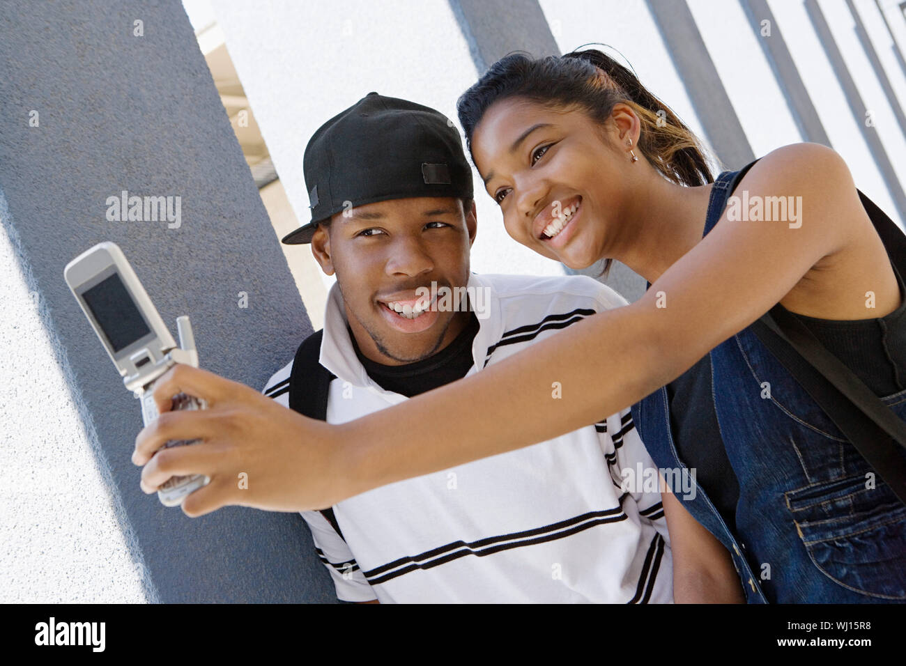 Happy classmates self photographing in the corridor of the college ...