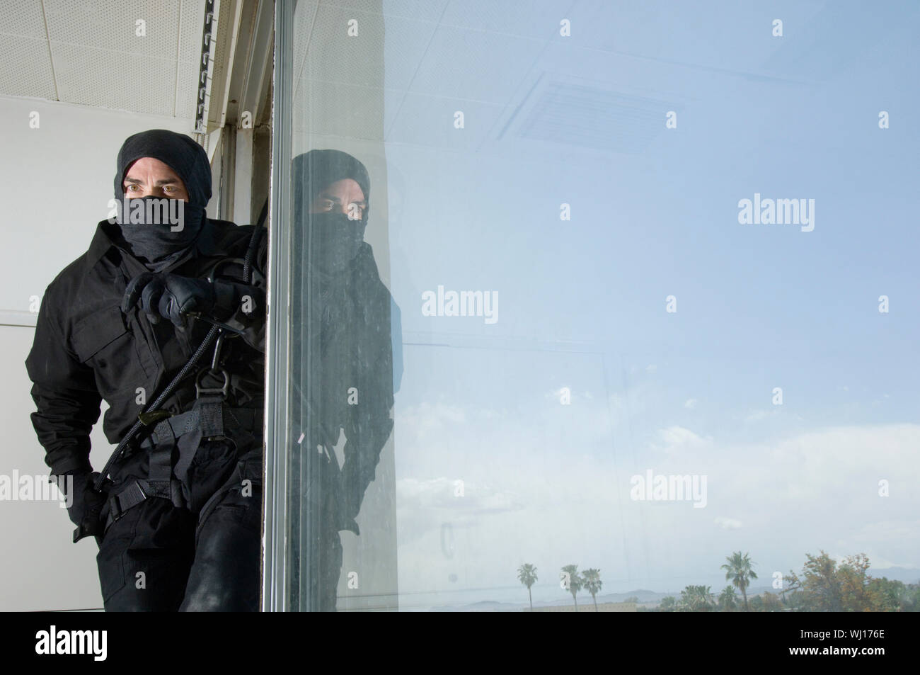 Mature military man standing at window of building Stock Photo - Alamy