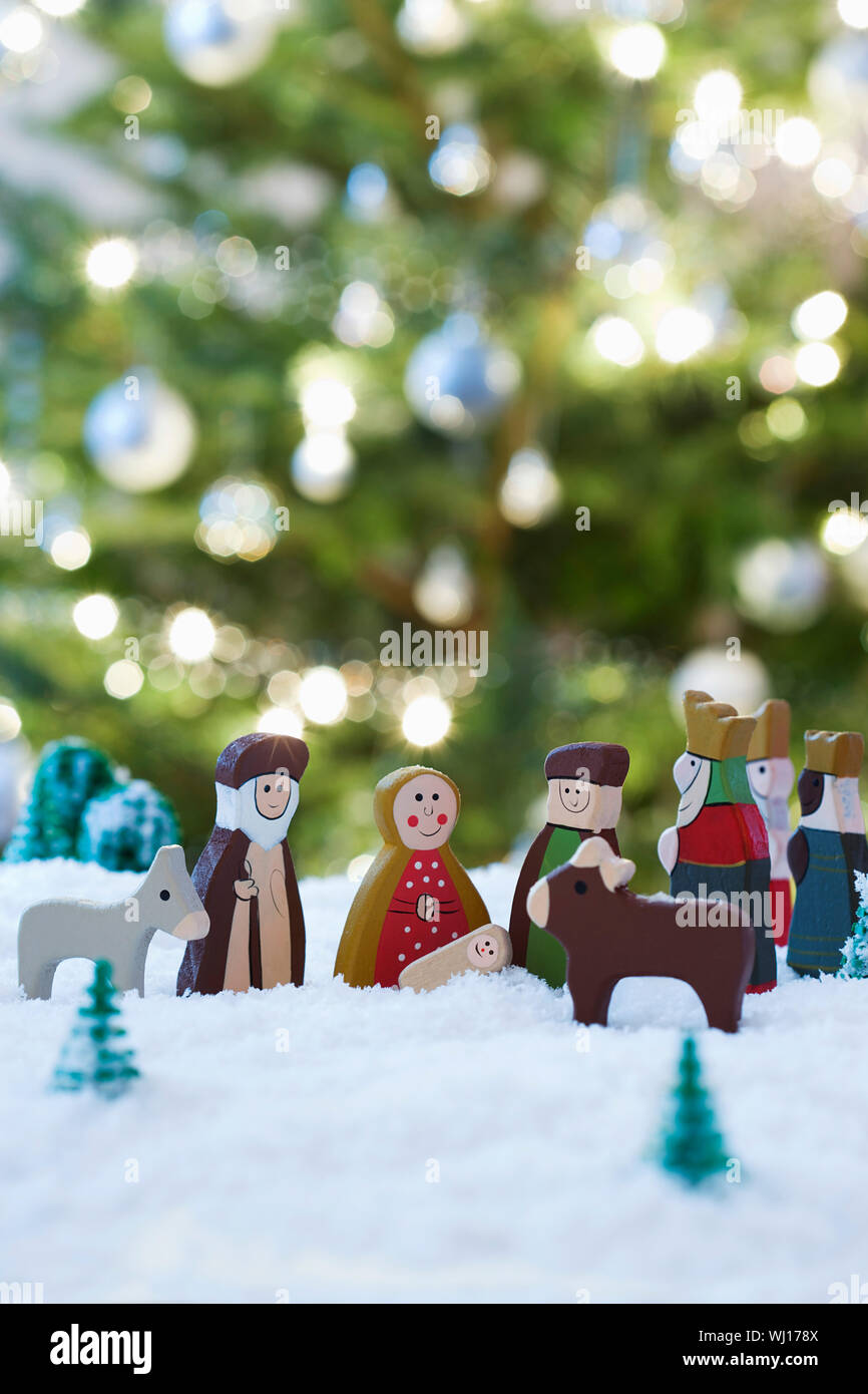 Nativity scene of Jesus birth with Christmas tree in background Stock ...