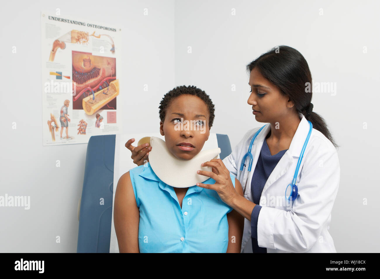 Female doctor puting brace on patient's neck Stock Photo - Alamy