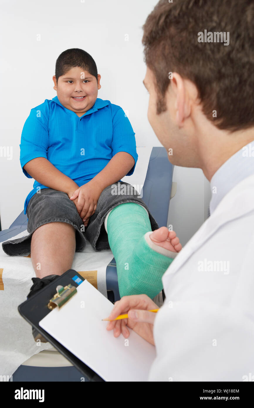 Doctor interviewing boy-patient Stock Photo - Alamy