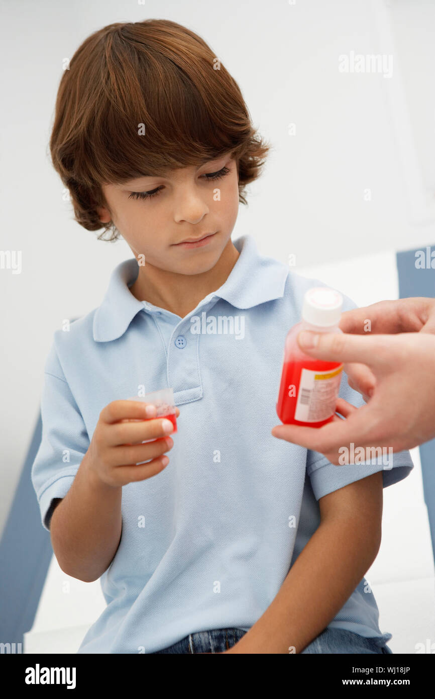 Boy taking medicine Stock Photo - Alamy
