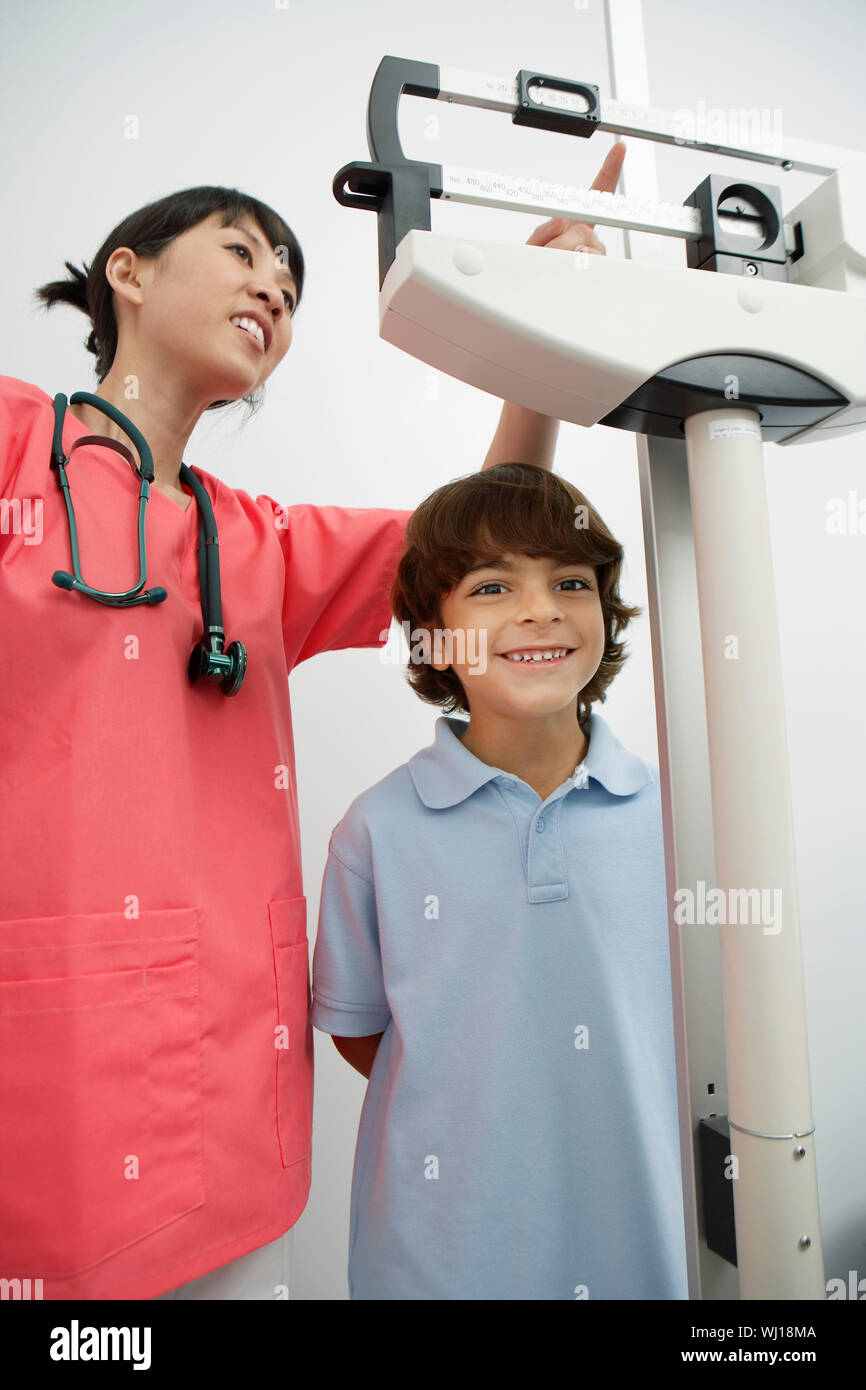 Female doctor weighting patient Stock Photo - Alamy