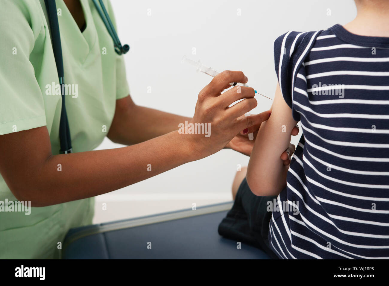 Boy receiving injection,close-up Stock Photo - Alamy