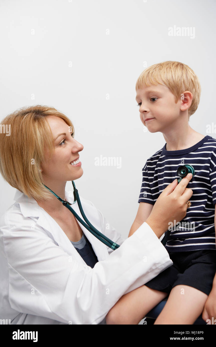 Boy being examined by female doctor Stock Photo - Alamy