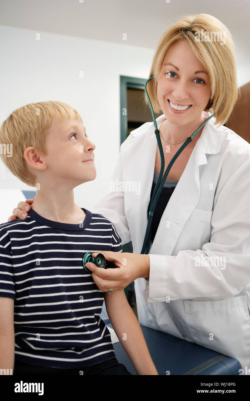 Young female doctor examining boy Stock Photo - Alamy