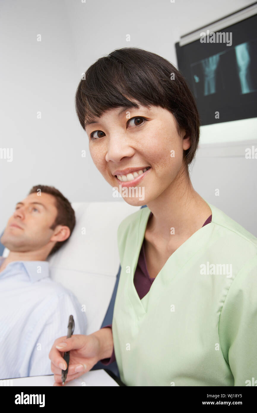 Doctor with male patient in hospital Stock Photo - Alamy