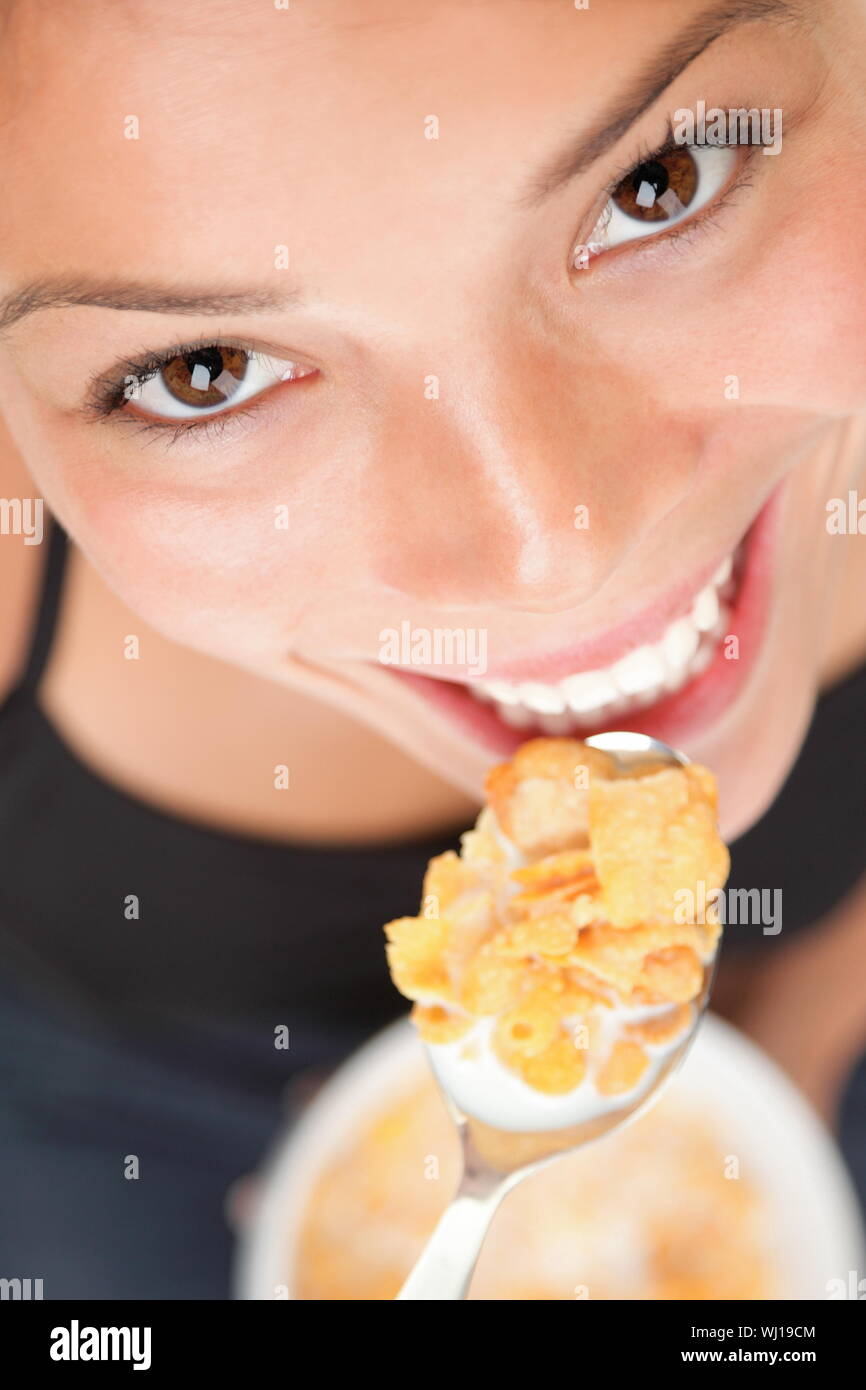 Cornflakes. Woman eating cornflakes cereals - closeup Stock Photo - Alamy