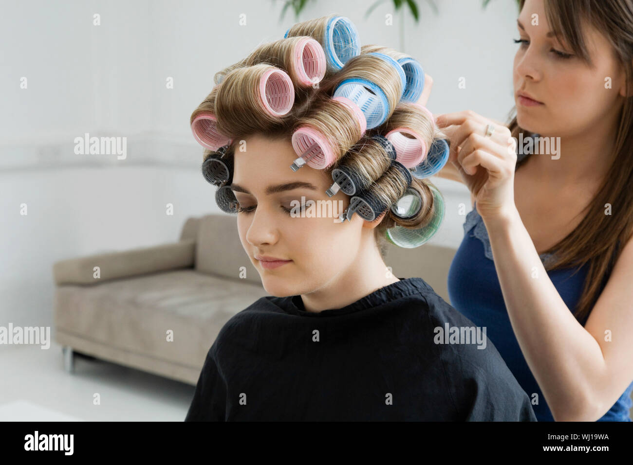 Young model in hair rollers hi-res stock photography and images - Alamy