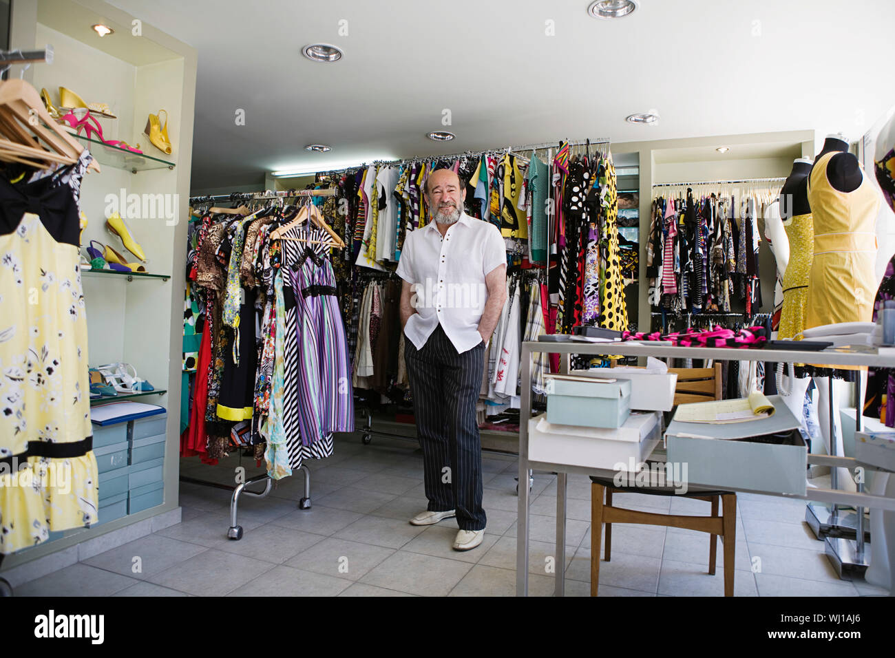 Full length portrait of a smiling male owner in clothing store Stock ...
