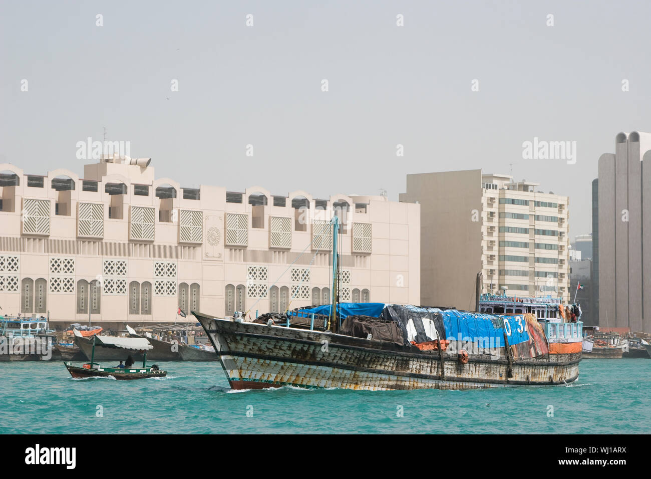 Dubai, UAE, A dhow, an old wooden sailing vessel, filled with cargo ...